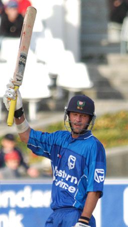 Andrew Puttick salutes the crowd after reaching his half century ...