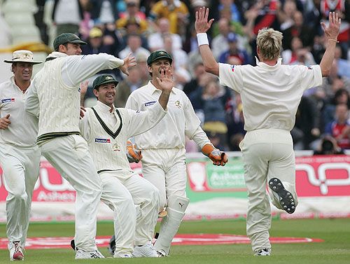 Brett Lee hares towards his team-mates as Michael Vaughan falls ...