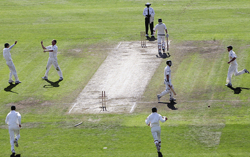 England celebrate after Andrew Flintoff bowls Simon Katich ...