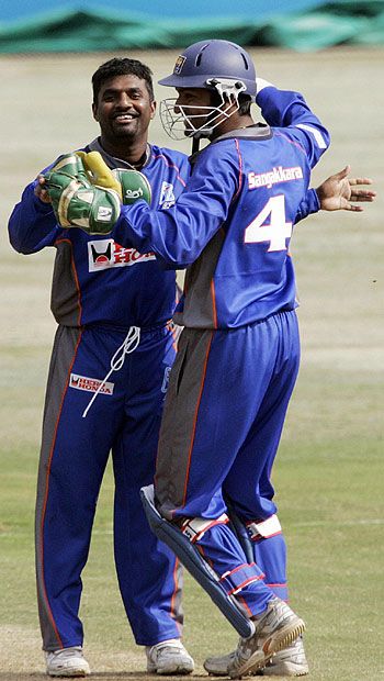 Muttiah Muralitharan and Kumar Sangakkara celebrate after the fall of ...