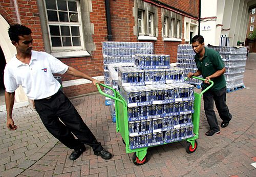 The necessary nectar: a case-load of beer is wheeled into The Oval ...