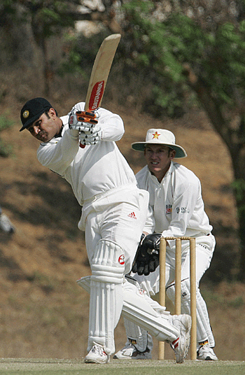 Virender Sehwag sends one to the midwicket boundary during his century ...