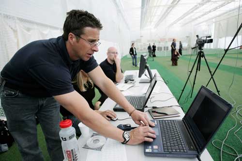 Troy Cooley stares intently at his laptop | ESPNcricinfo.com