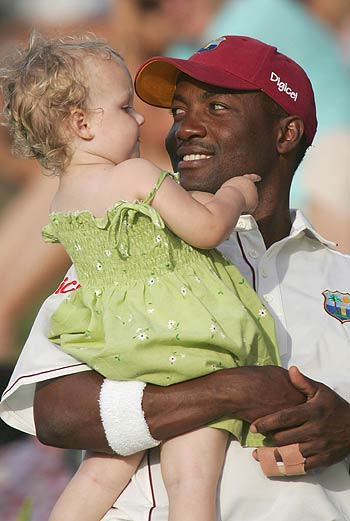 Brian Lara poses with a baby | ESPNcricinfo.com