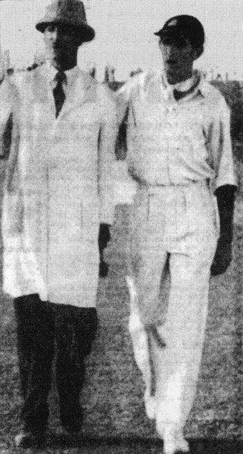 Idris Begh and Donald Carr leave the field at the close of play ...