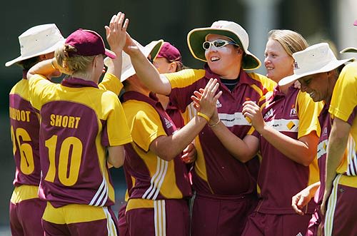 Queensland players celebrate the wicket of Michelle Goszko ...