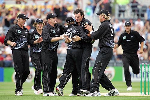 Kyle Mills is congratulated after dismissing Adam Gilchrist ...