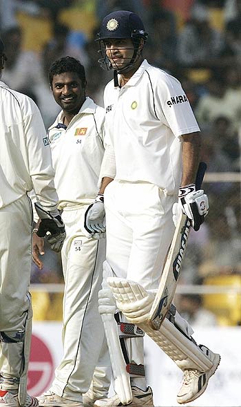 Muttiah Muralitharan looks on as Irfan Pathan walks back to the pavilion | ESPNcricinfo.com
