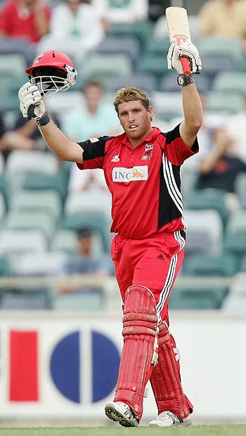 Mark Cosgrove raises his bat after reaching his century | ESPNcricinfo.com