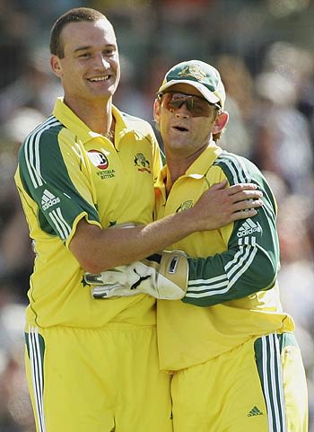 Adam Gilchrist hugs Stuart Clark after the fall of Russel Arnold ...
