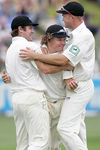 Hamish Marshall is mobbed by Peter Fulton and Jamie How after taking ...