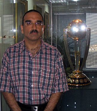 Anoop Gidwani poses in front of the ICC Cricket World Cup ...