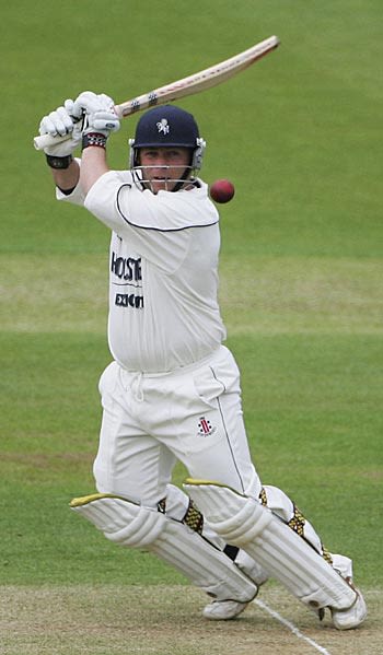 Matthew Walker hammers a boundary during his century against Middlesex ...