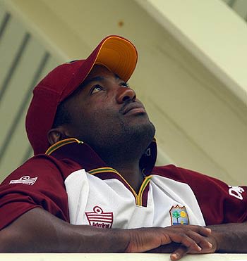 Brian Lara looks at the gloomy skies from the dressing room ...