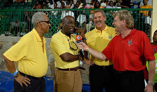 Sir Viv Richards, Sir Garry Sobers and Allen Stanford share a light ...