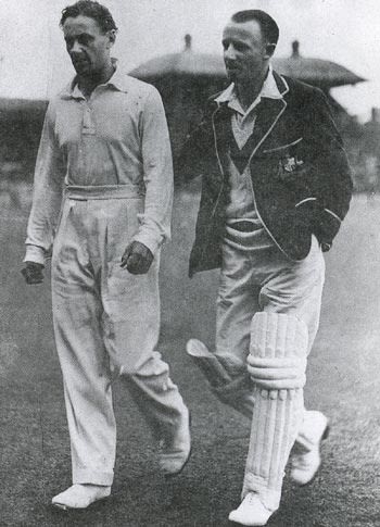 Gubby Allen and Don Bradman return to the pavilion during a rain delay ...