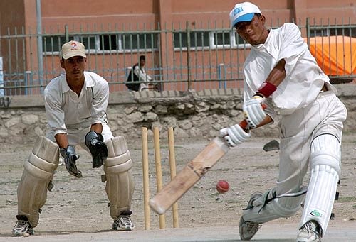 A cricket match in progress outside the national stadium in Kabul ...
