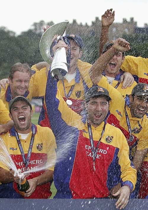 Ronnie Irani leads the celebrations and holds the Pro40 trophy aloft ...