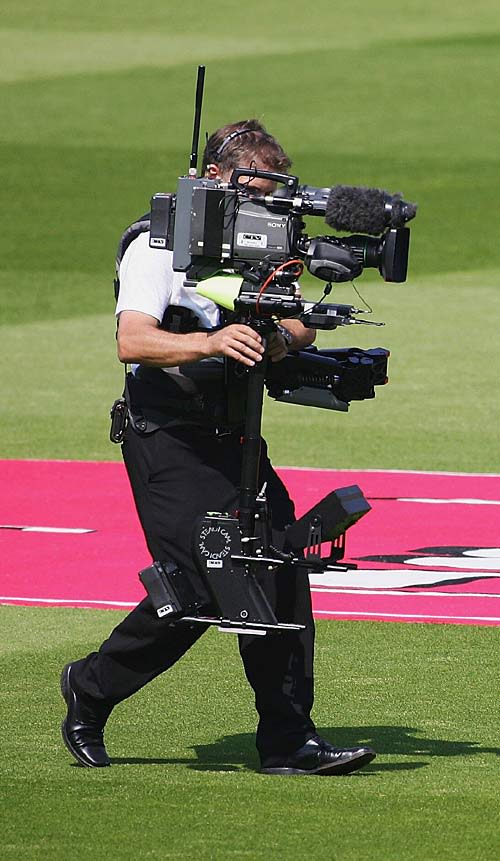 A television cameraman follows the two batsmen to the middle ...