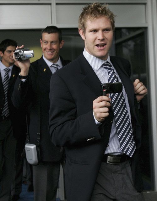 Matthew Hoggard and Ashley Giles (behind) film their arrival at Sydney ...