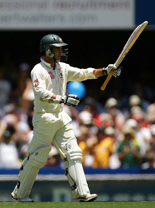 Justin Langer raises his bat after reaching his half-century ...