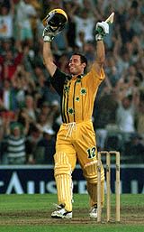 Michael Bevan raises his arms in triumph after hitting a four off the ...