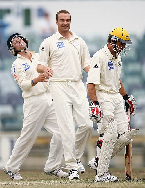 Stuart Clark is congratulated on one of his eight wickets ...