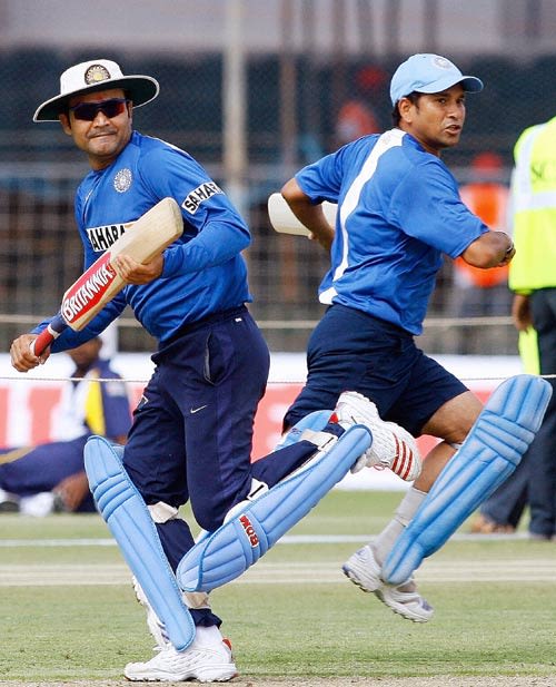 Sachin Tendulkar and Virender Sehwag practise running between the ...