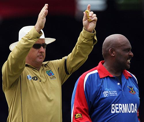 A hapless Dwayne Leverock looks on as yet another six is hit. Leverock ...