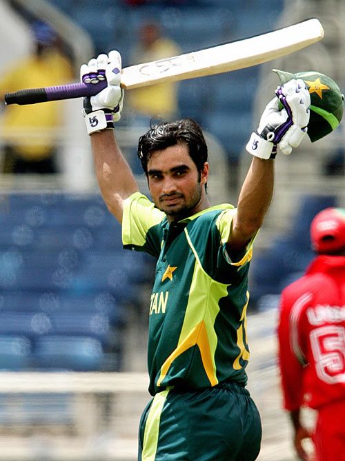 Imran Nazir raises his arms to celebrate his hundred against Zimbabwe ...