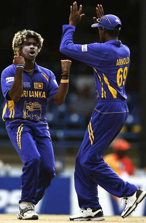 Lasith Malinga and Russel Arnold celebrate the wicket of Tamim Iqbal ...