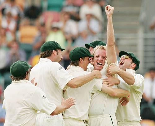 Damien Wright's team-mates swamp him after he took the final wicket ...