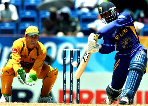 Chamara Silva drives square as Adam Gilchrist looks on | ESPNcricinfo.com