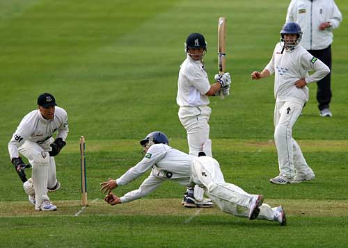 Carl Hopkinson dives to take a bat-pad chance off Jonathan Trott ...
