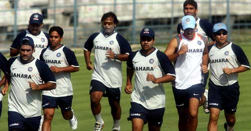 Indian cricketers jog around the outfield of Eden Gardens ...