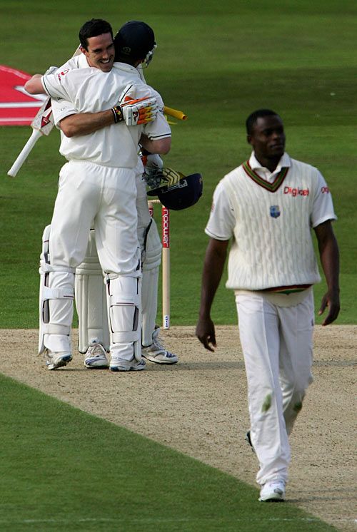 Kevin Pietersen celebrates his hundred as Daren Powell looks on ...