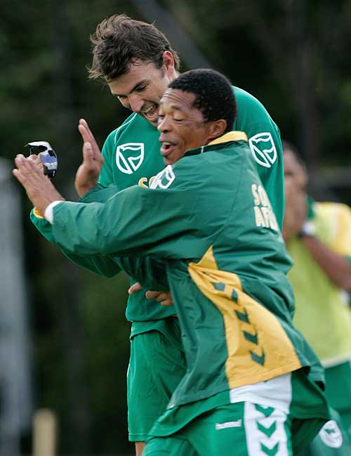 Makhaya Ntini and Justin Kemp lark around during training ...