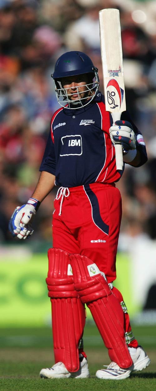 Brad Hodge raises his bat after reaching his half-century ...
