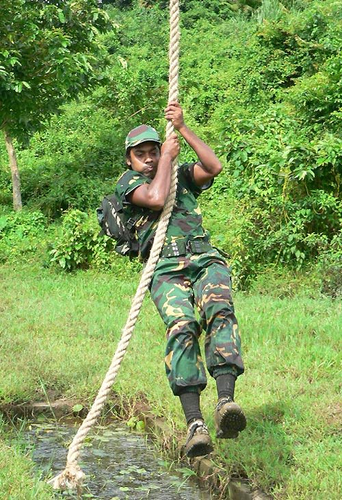 Syed Rasel completes a tarzan swing at the obstacle course ...