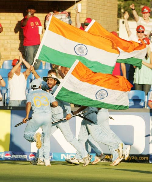 Indian players wave the flags as they run the lap of honour ...