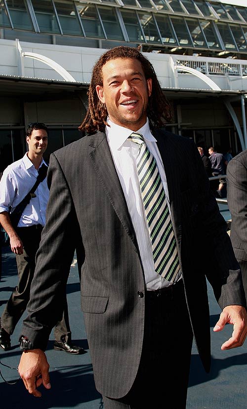 Andrew Symonds is all smiles as he arrives home from an eventful tour ...