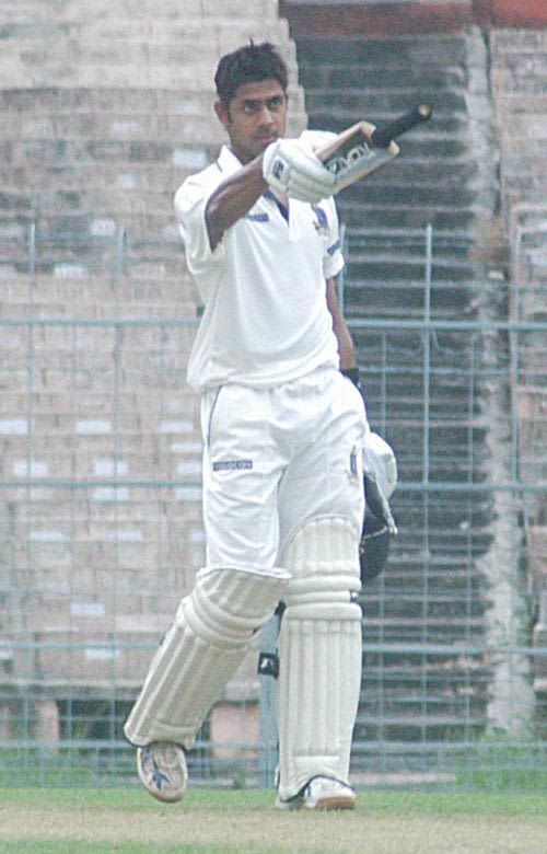 Manoj Tiwary points to the pavilion after reaching his century ...