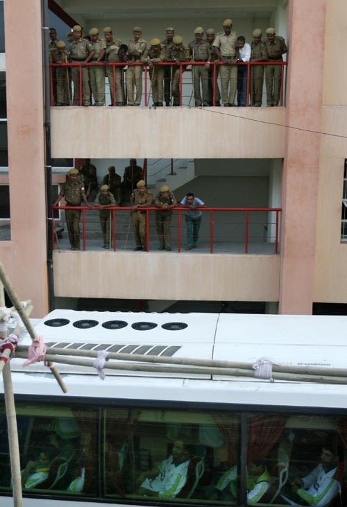 Security personnel keep a close watch on Pakistan's team bus ...
