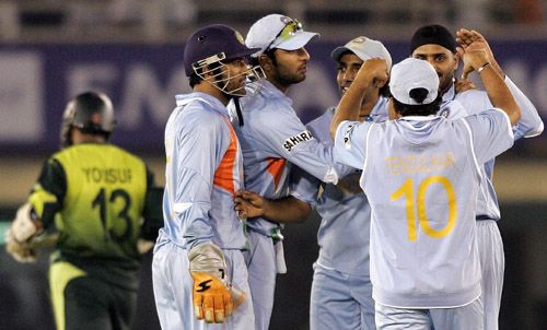 The Indian players celebrate the wicket of Mohammad Yousuf ...