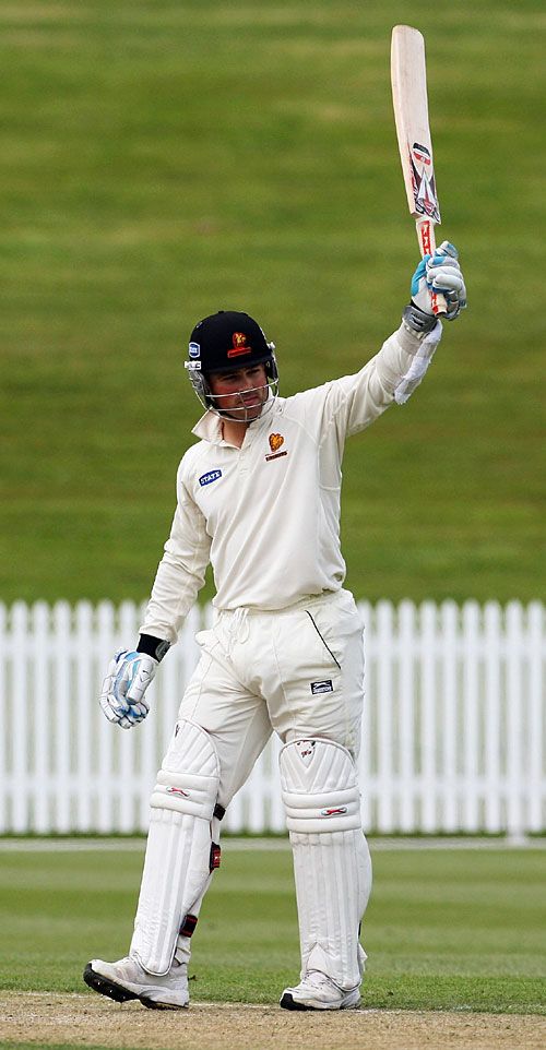 Matthew Bell raises the bat after reaching his half-century for ...