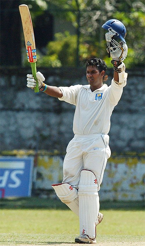 Chamara Kapugedera raises his bat after reaching his hundred ...