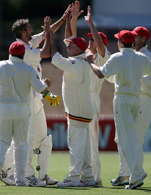 The Redbacks congratulate Jason Gillespie on one of his seven wickets ...