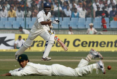 Wasim Jaffer gets the ball past Salman Butt in the covers ...