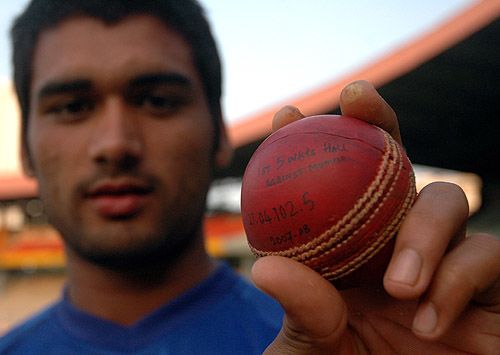 Delhi's Pradeep Sangwan proudly shows off the ball with which he took a ...
