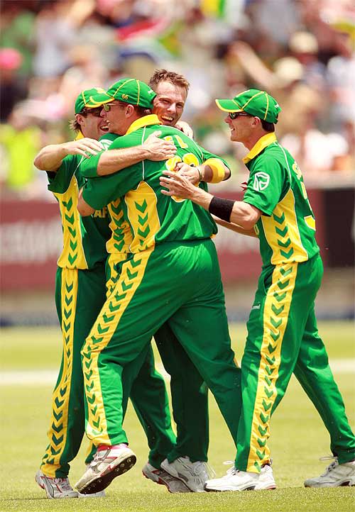 Johan Botha is congratulated by his team mates after picking up Scott ...